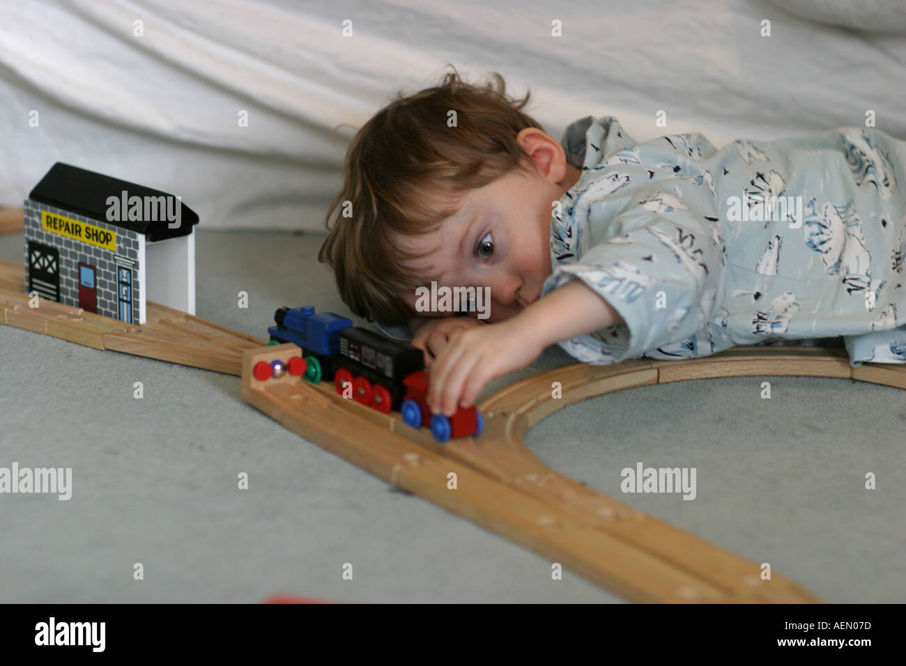 Lewis and his wooden train set Stock Photo - Alamy