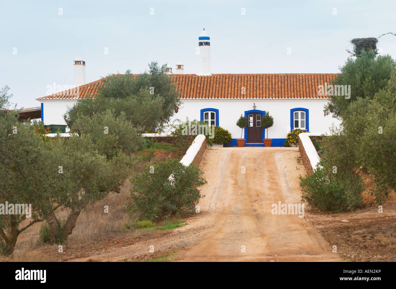 The old farm house in traditional Portuguese style. Dirt road. Herdade ...