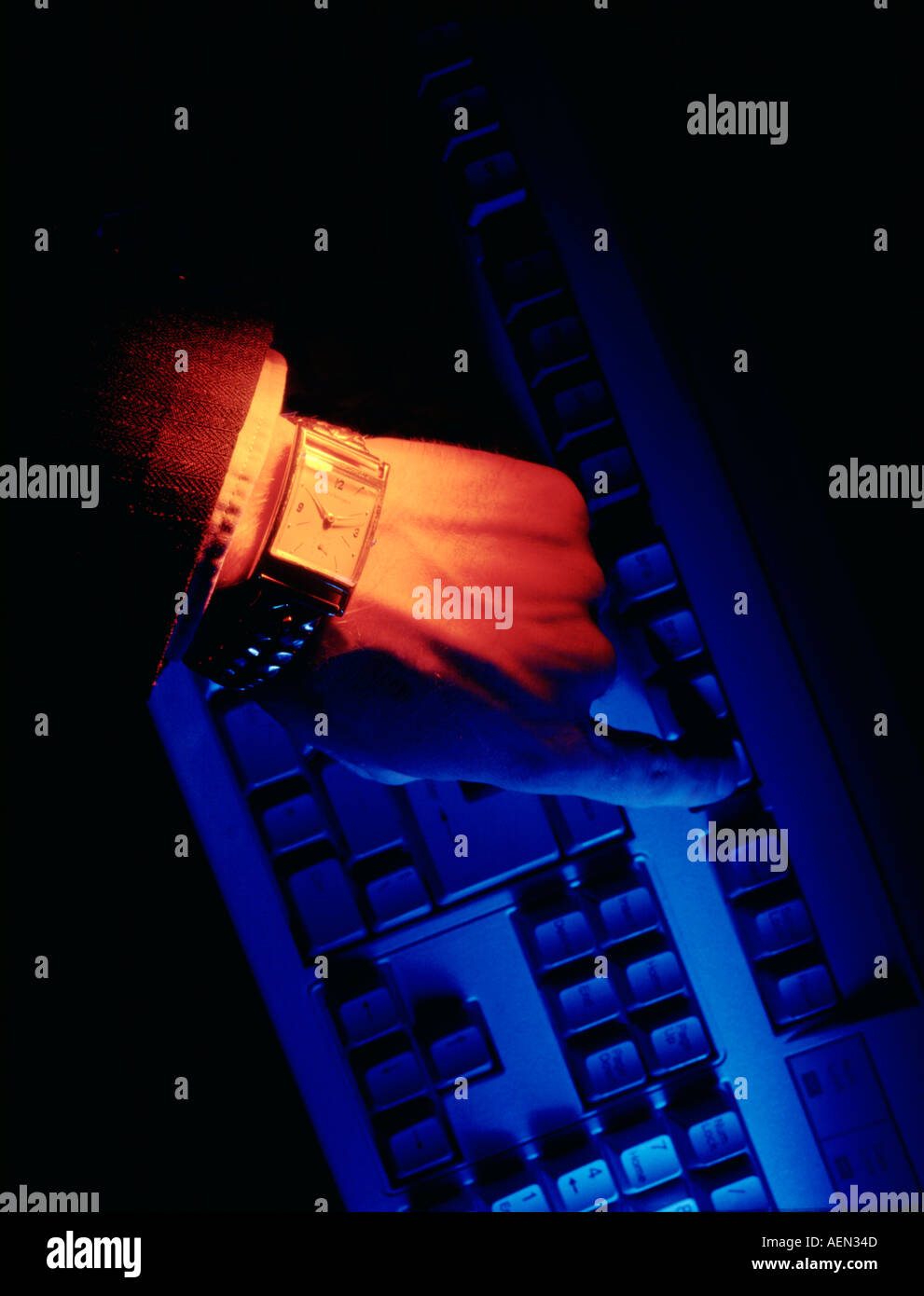 hand wearing gold wrist watch, using computer keyboard Stock Photo - Alamy