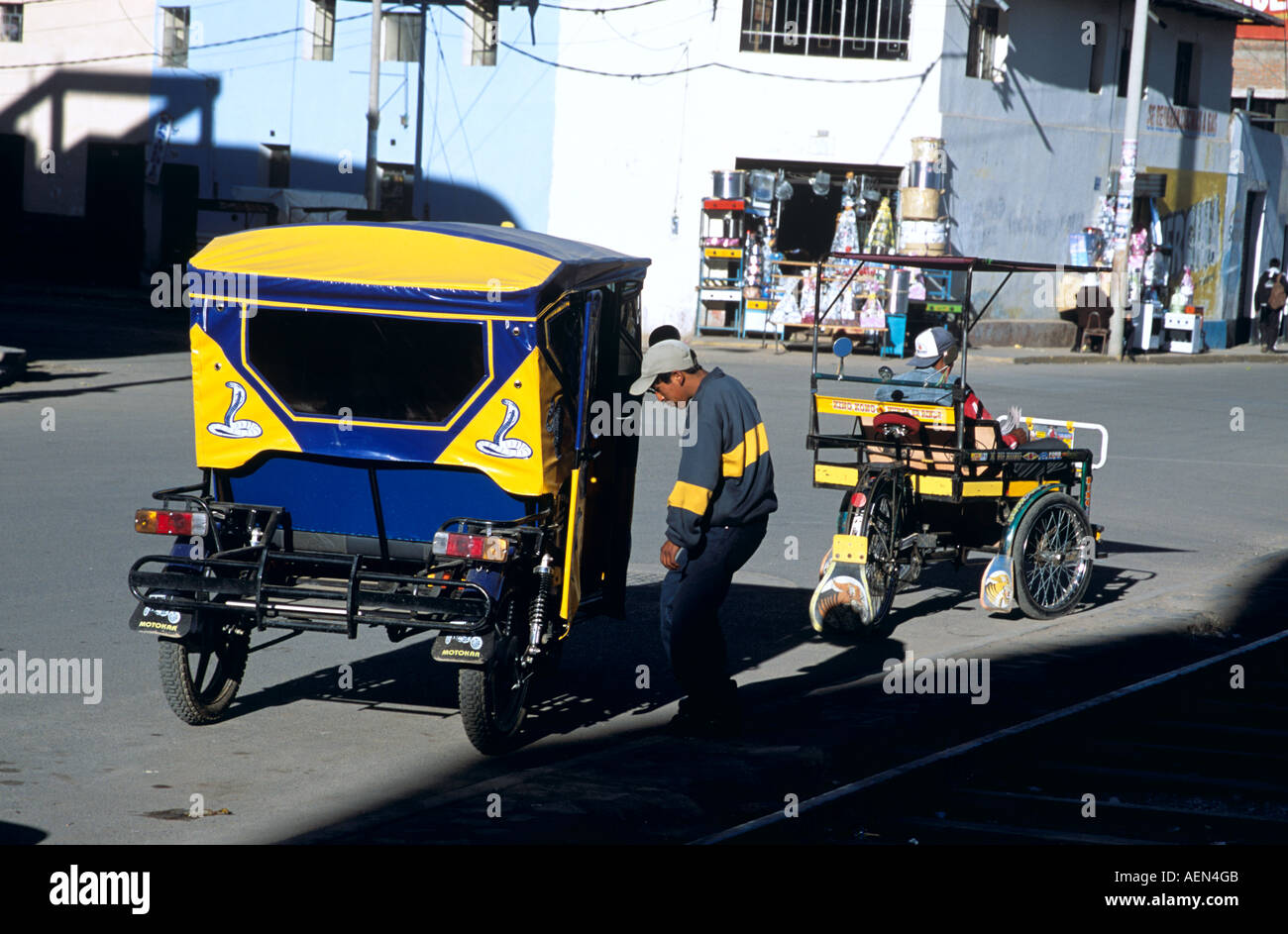 Three wheeled taxi and customer, and tricycle taxi, Puno, Peru Stock ...