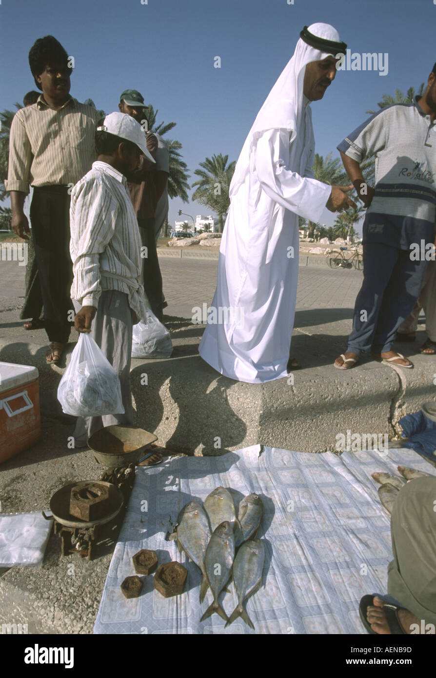 Fishermen selling fish at dockside market in Doha Qatar Stock Photo - Alamy
