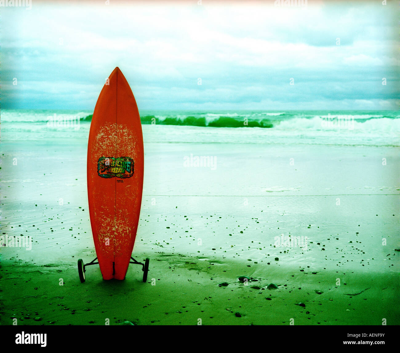 A surfboard, beach side with training wheels Stock Photo - Alamy