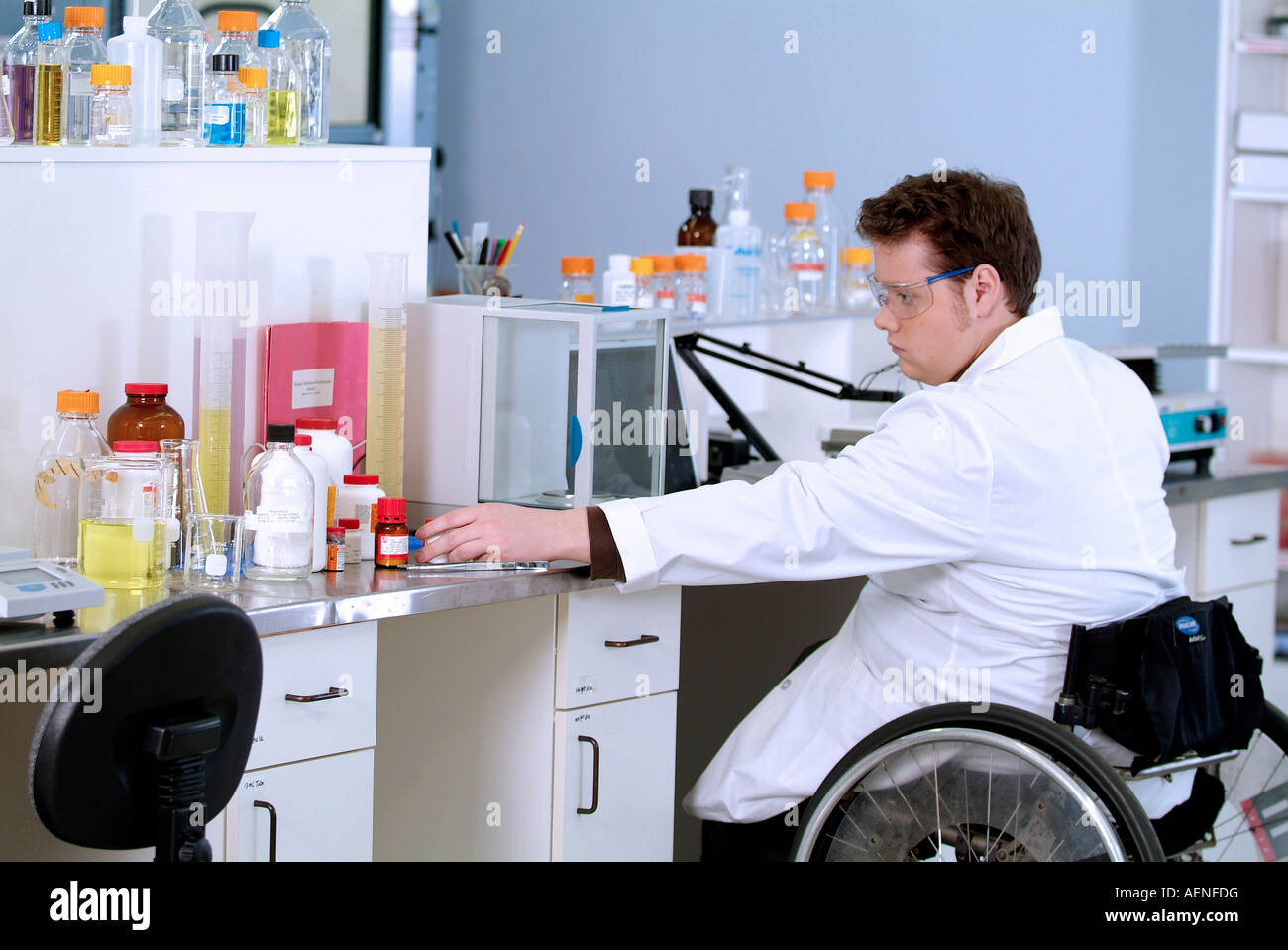 A man in a wheel chair working in a lab Stock Photo - Alamy