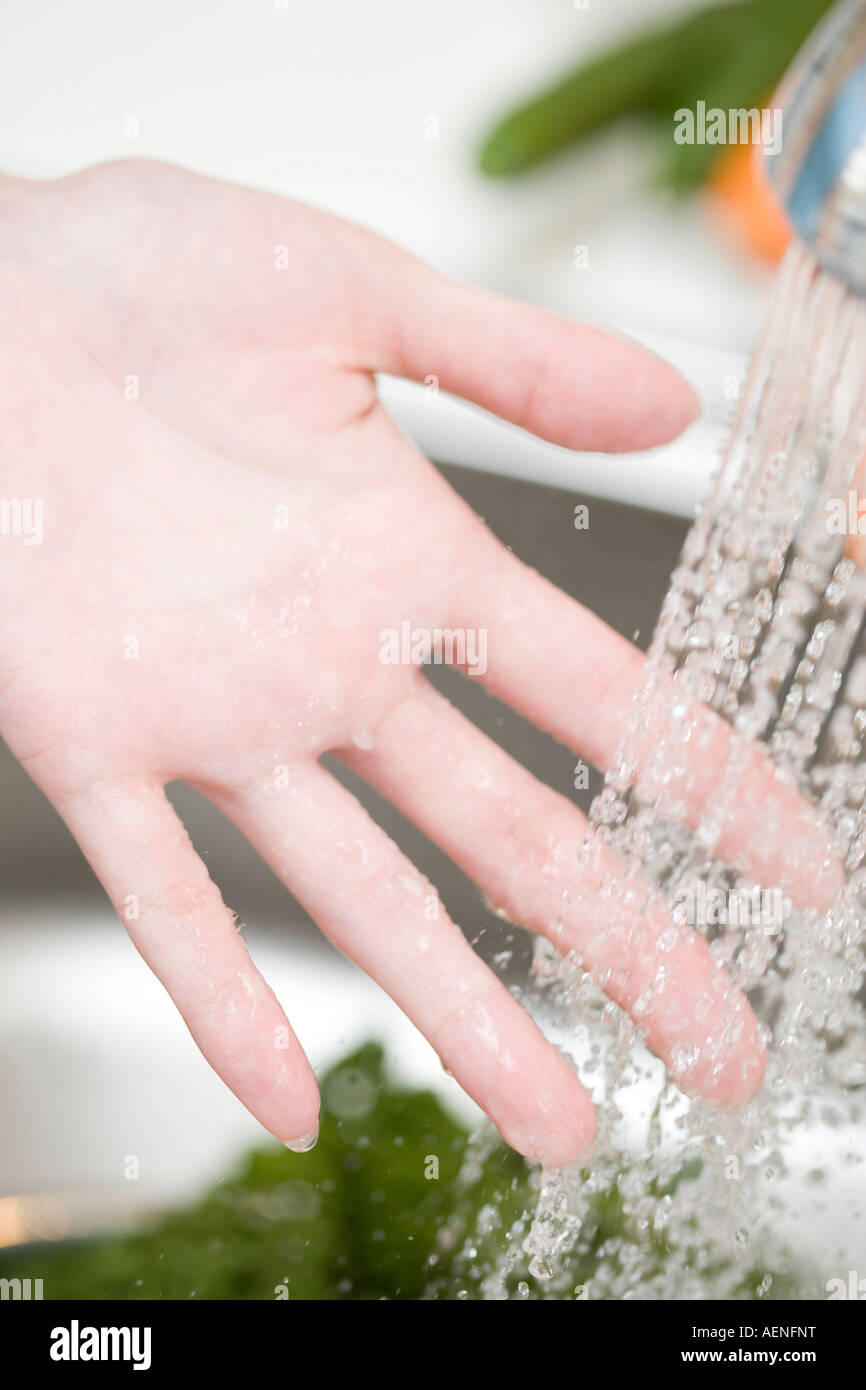 Hand before woman cooking Stock Photo - Alamy
