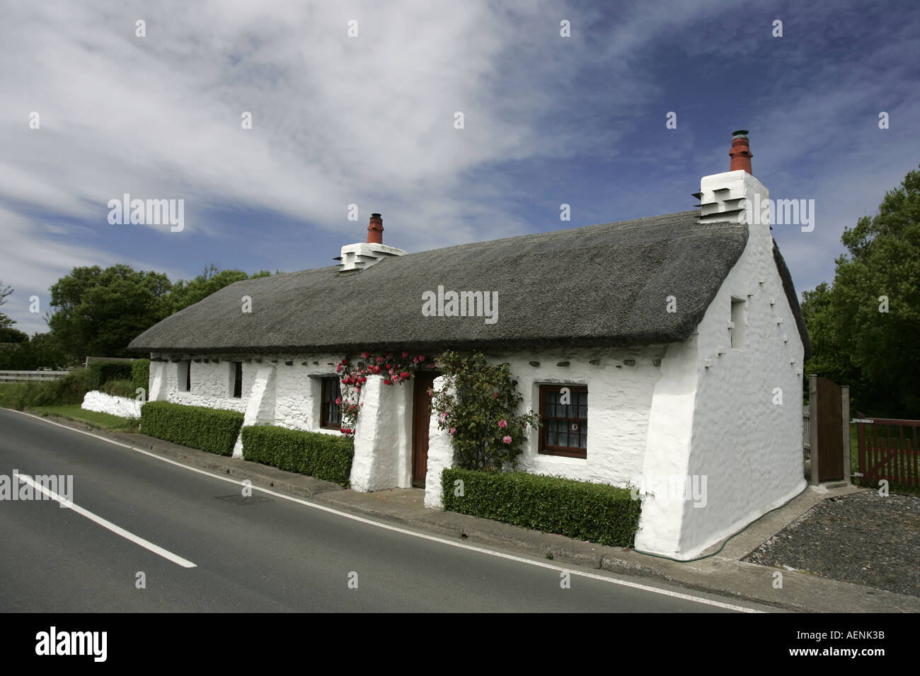 Traditional manx thatched cottage by road near Point of Ayre Isle of ...
