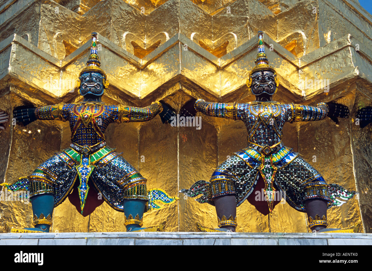 Guardian mythical demons supporting golden chedi, Grand Palace, Bangkok ...