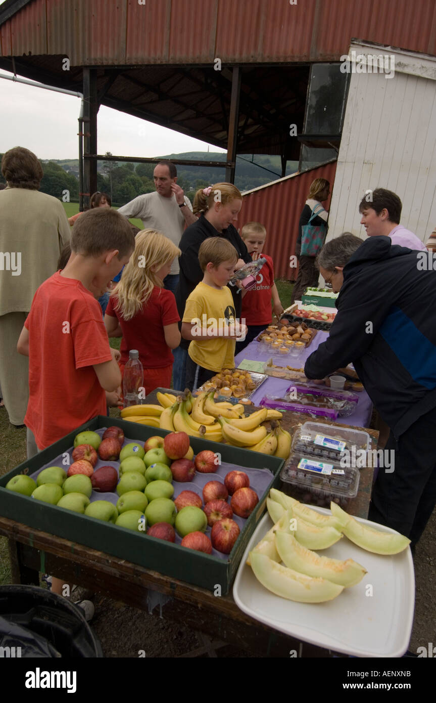 Pupils buying fresh fruit at their School sports day Ysgol Gymraeg ...