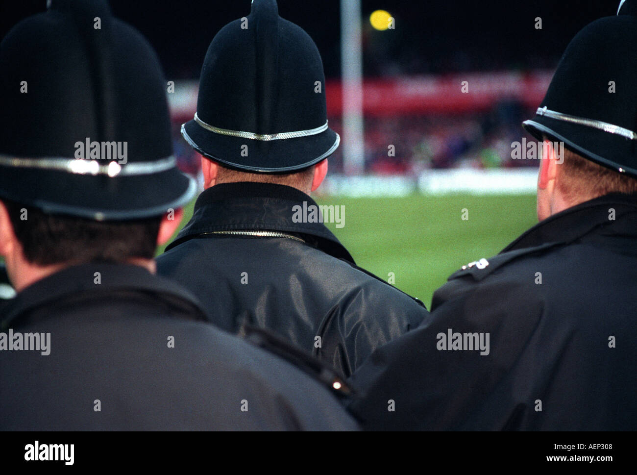 POLICING AT FOOTBALL POLICE OFFICERS WATCH THE GAME AND THE CROWD AT ...