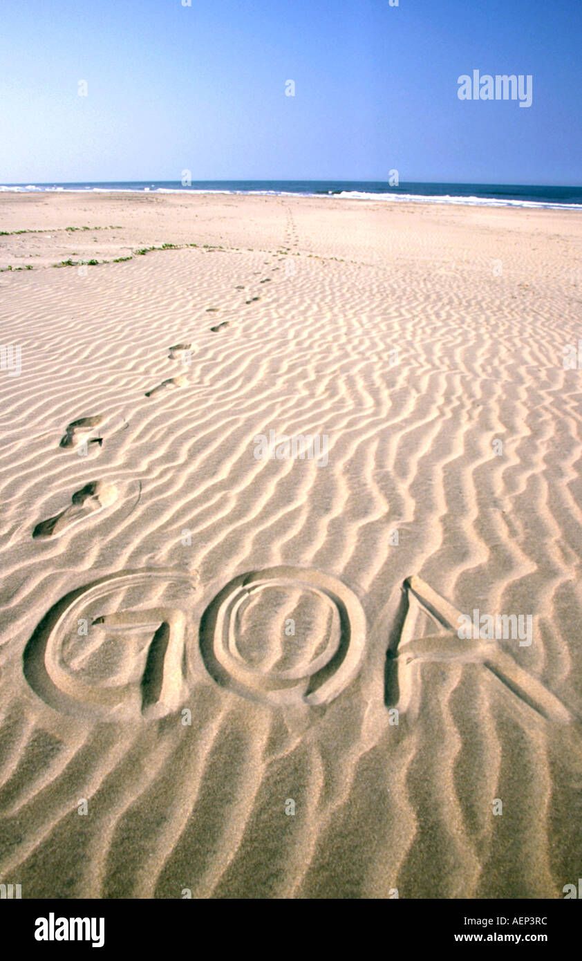 India word Goa written in rippled sand with line of footsteps Stock ...