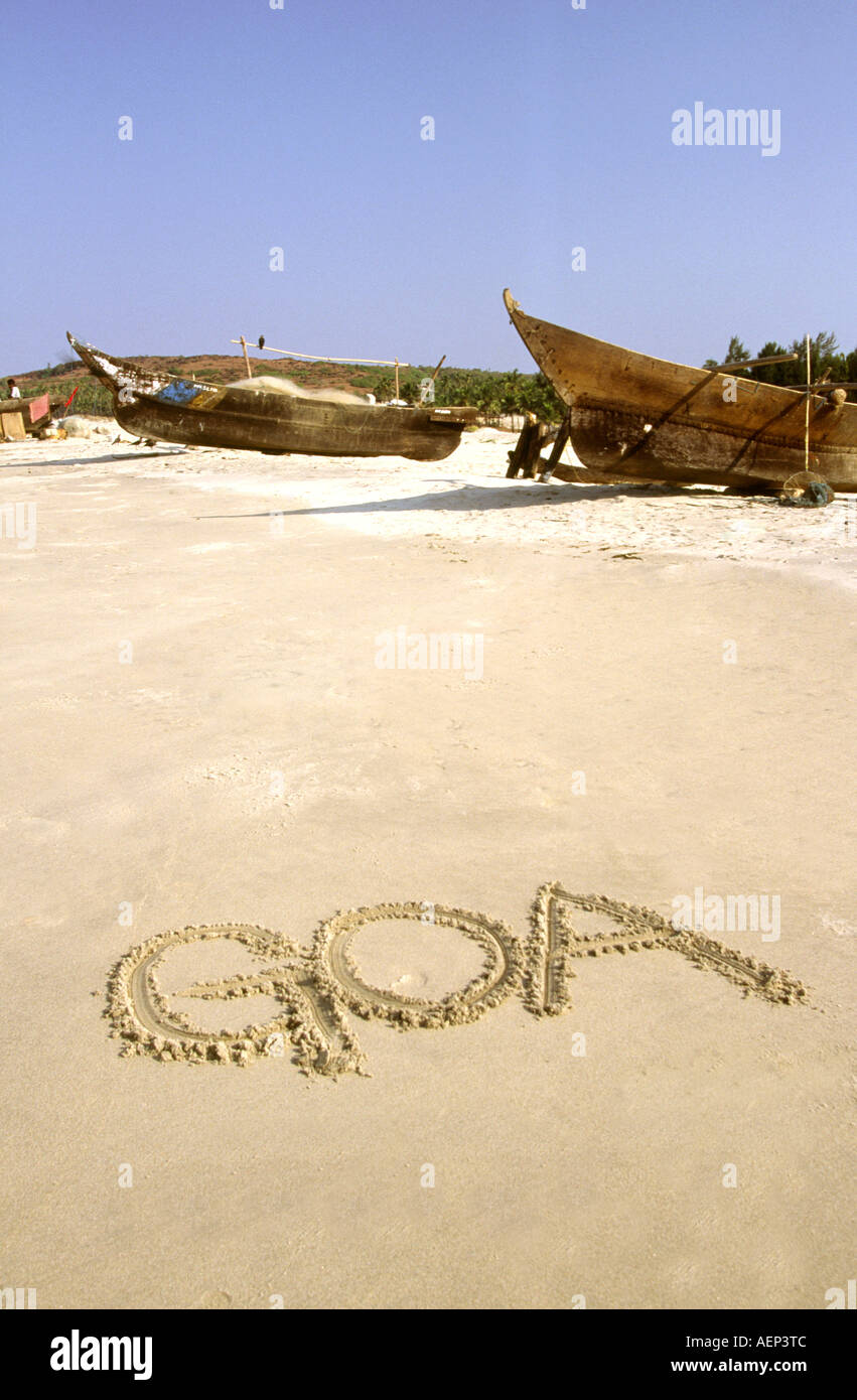 India Goa written in sand on empty beach with fishing boats Stock Photo ...