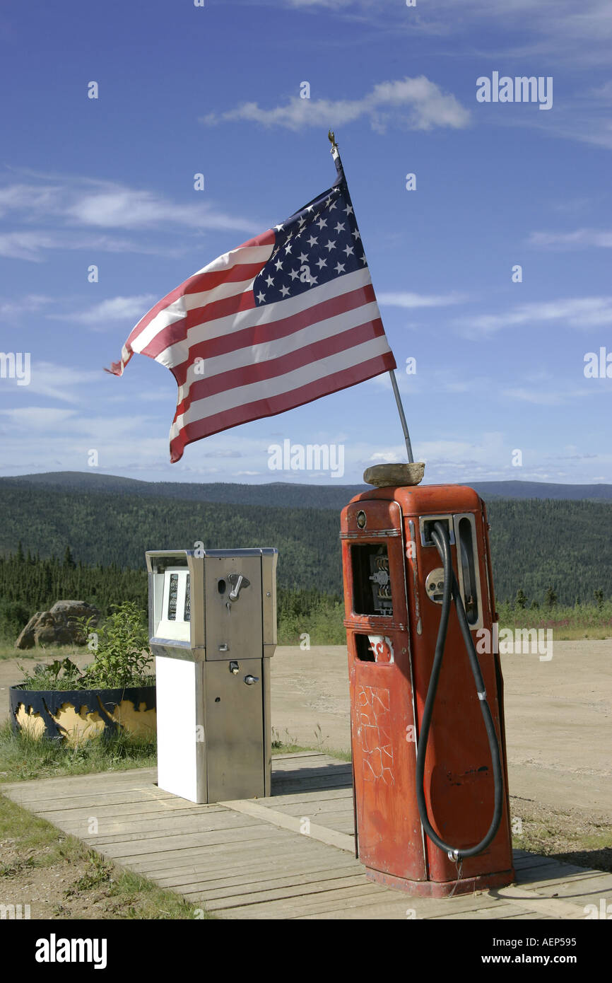 a gas station with an old gas pump and an american flag at theTop of ...