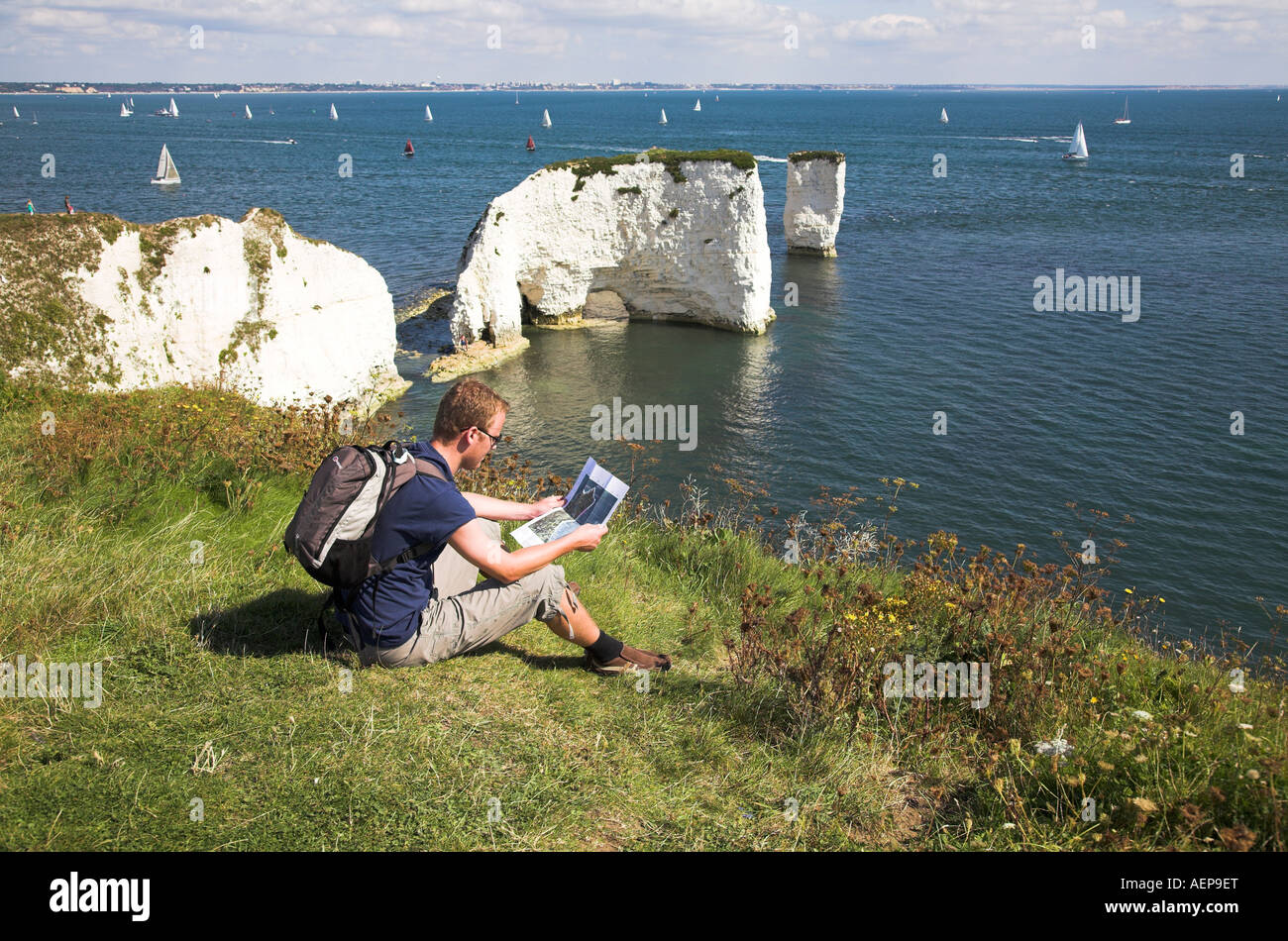 Student studying a map on a hike along the cliffs near to Old Harry ...