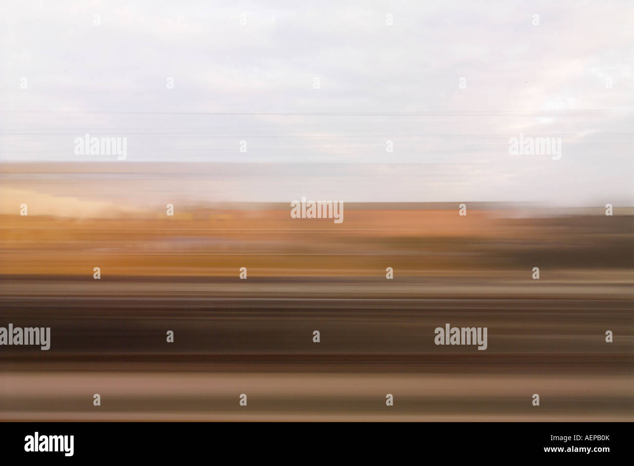 yellow train zooming past Stock Photo - Alamy