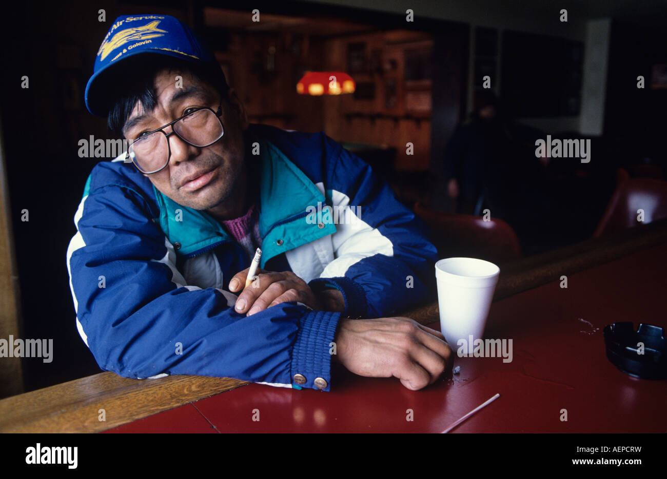 USA Alaska Yupik Eskimo man sits in Board of Trade Bar in downtown Nome ...