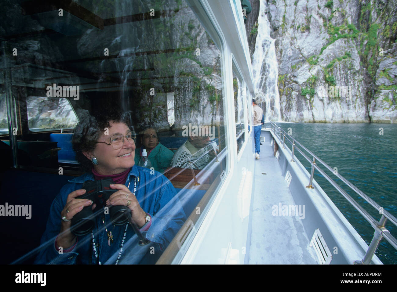 USA Alaska Kenai Fjords National Park Tourists peer through window at ...
