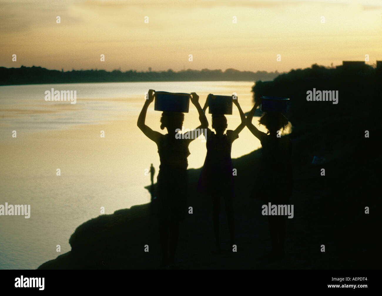 SUDAN Young girls carry water from the ile near Karthoum Stock Photo ...