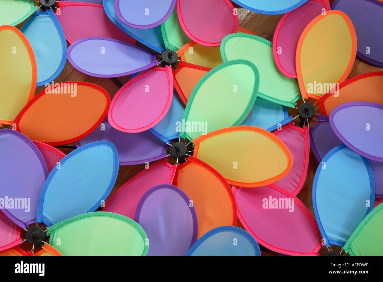 Close up on a mass of overlapping multi colored six vaned or petaled ...