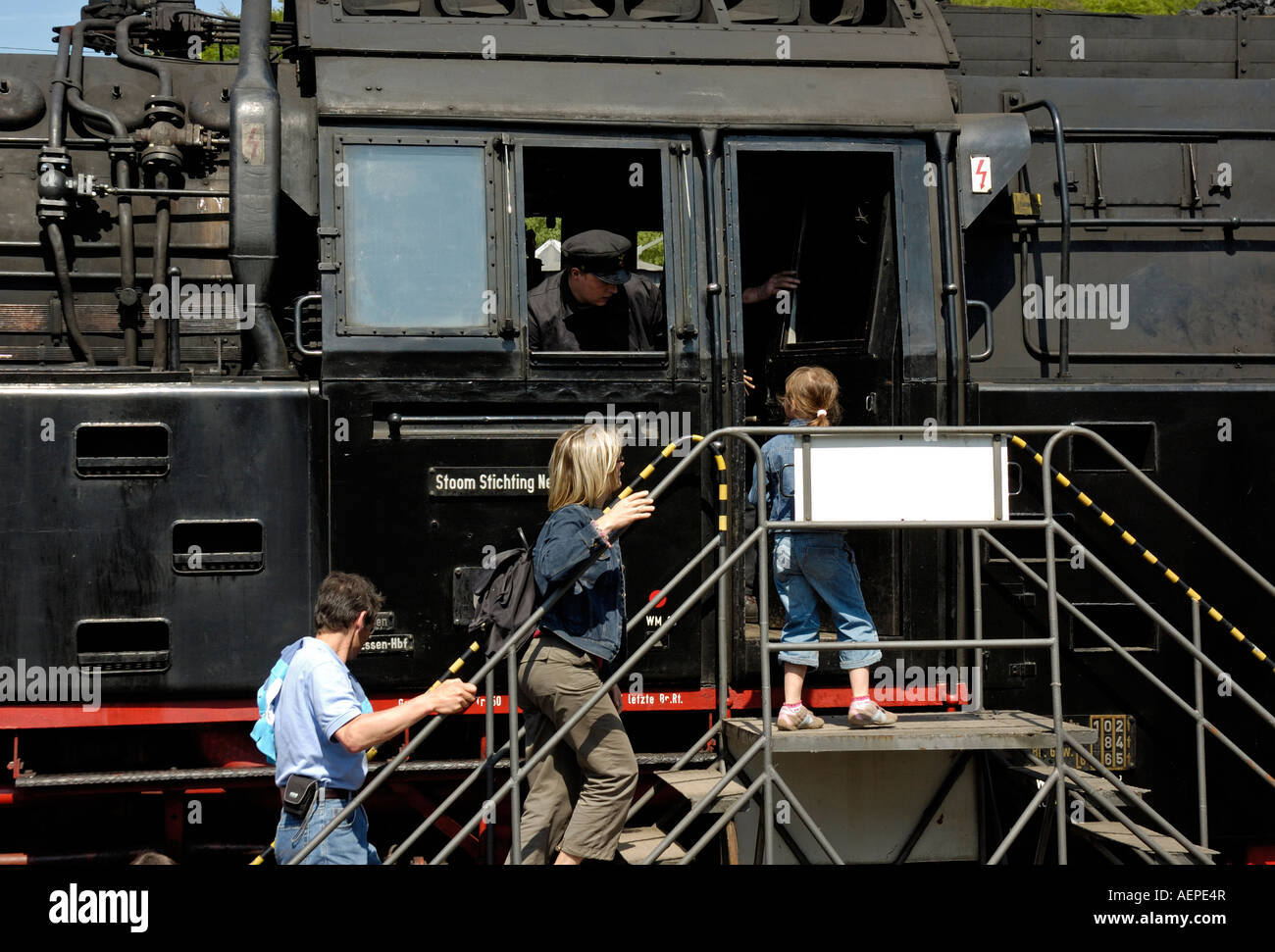 Man woman and child boarding steam locomotive for footplate ride Stock ...