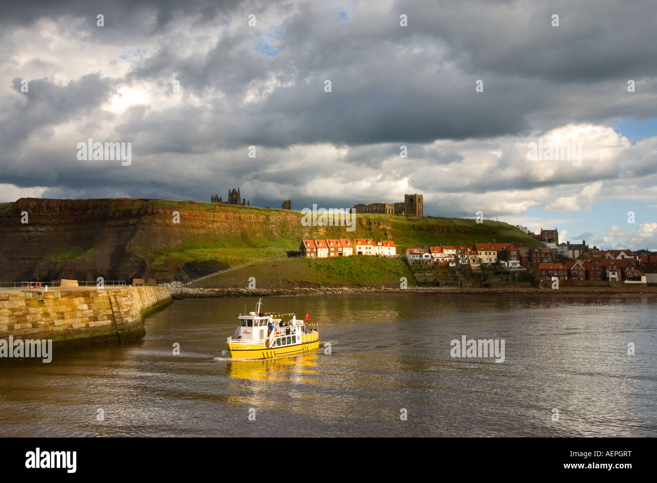 Boat in Whitby Harbour underneath Whitby Abbey Stock Photo - Alamy