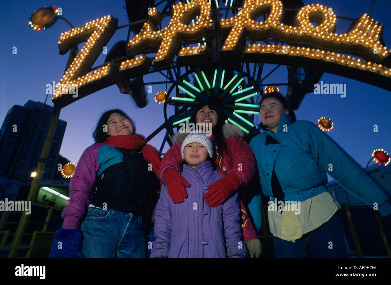 USA Alaska Eskimo family laughs in front of fair rides at Fur ...