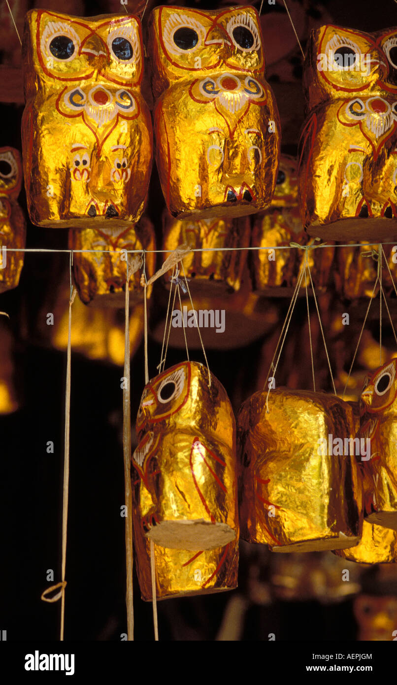 Gold wrapped owls symbolizing wisdom outside a pagoda in Yangon ...