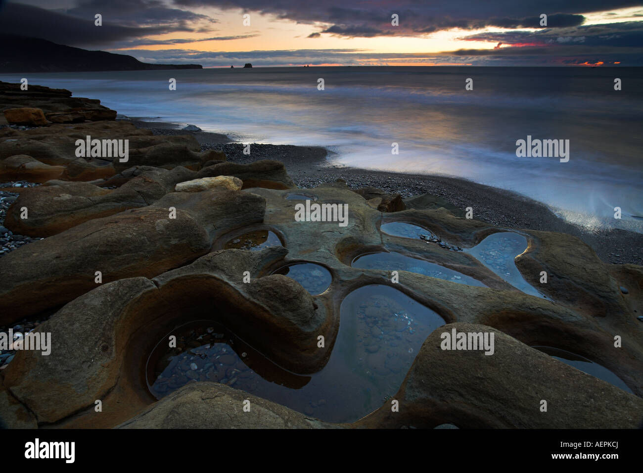Sandstone rockpools on the shore of Seven Mile Beach, New Zealand Stock ...