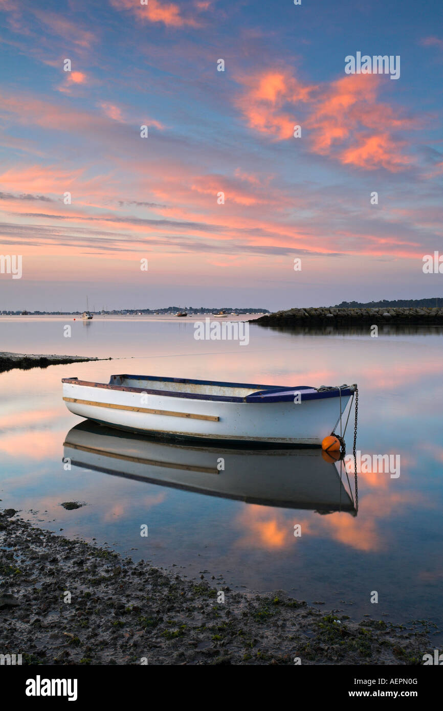 Small boat in Poole Harbour at dawn Stock Photo - Alamy