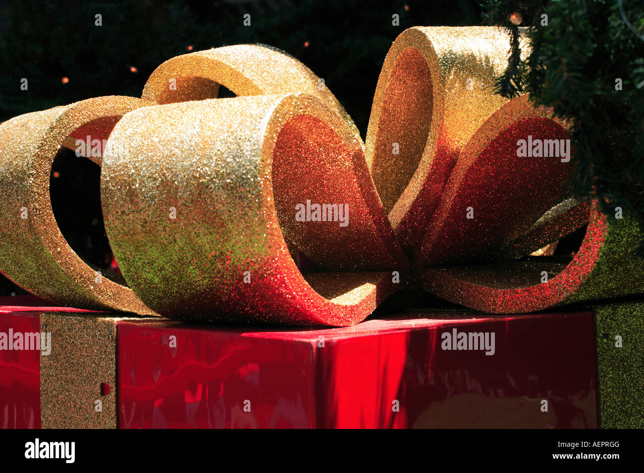 Large red gift box with golden bows detail Stock Photo - Alamy