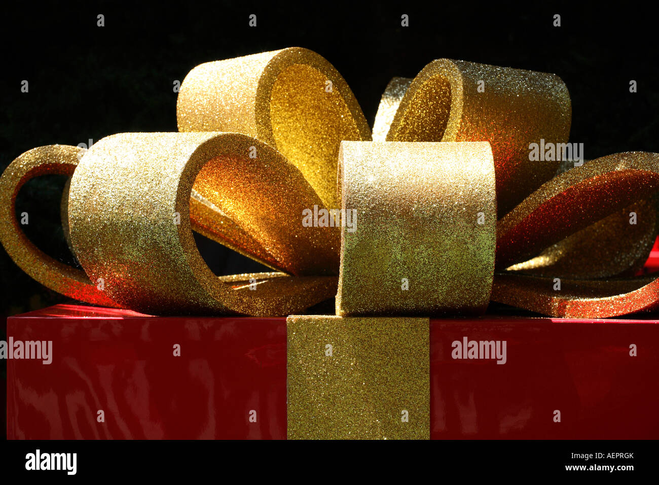 Large red gift box with golden bows detail Stock Photo - Alamy
