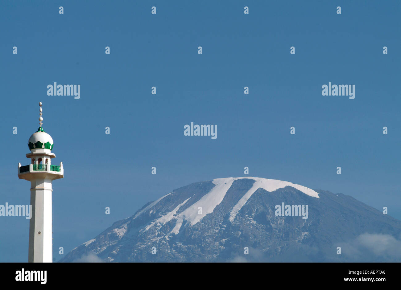 Islamic mosque minaret in foreground with Mount Kilimanjaro in the ...