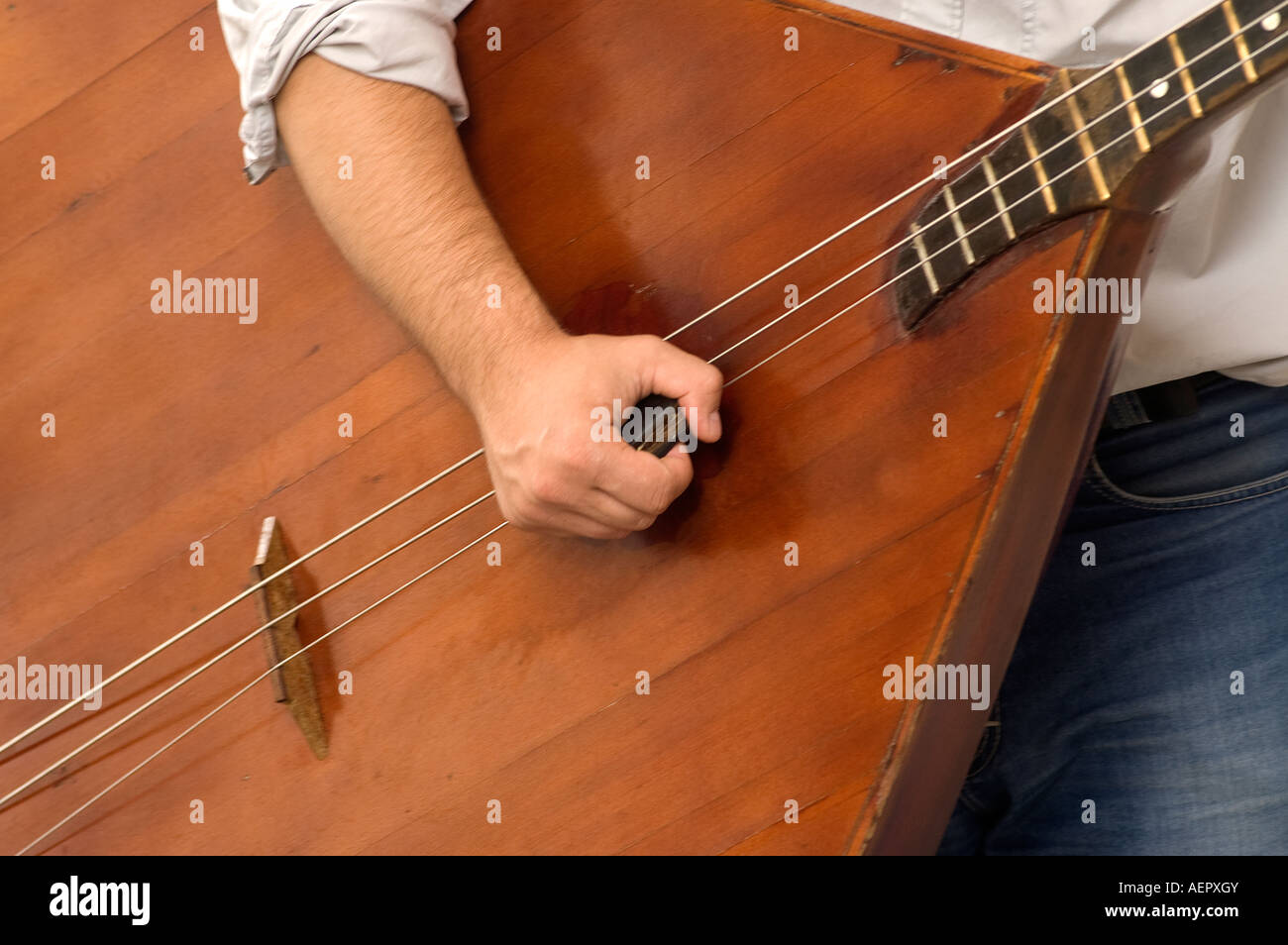A musician play with an old bass instrument Stock Photo - Alamy