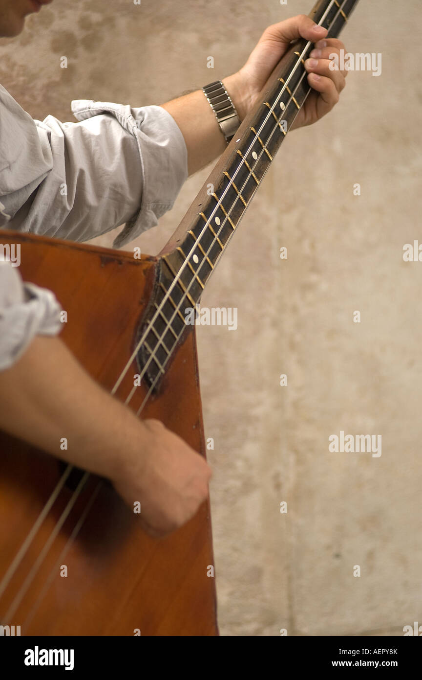 A musician play with an old bass instrument Stock Photo - Alamy