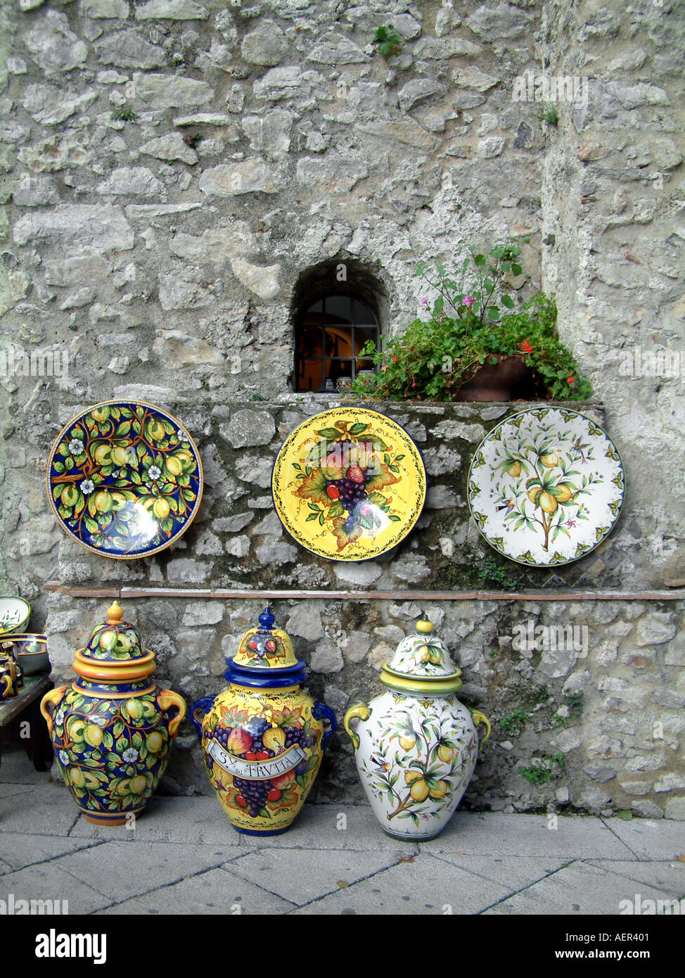 Traditional ceramic plates and pots on sale at the village square in ...