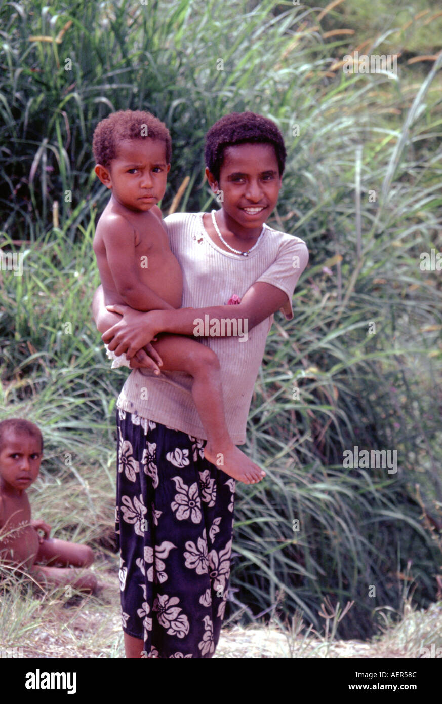 Girl carrying her young child, Mount Hagen, Papua New Guinea Stock ...