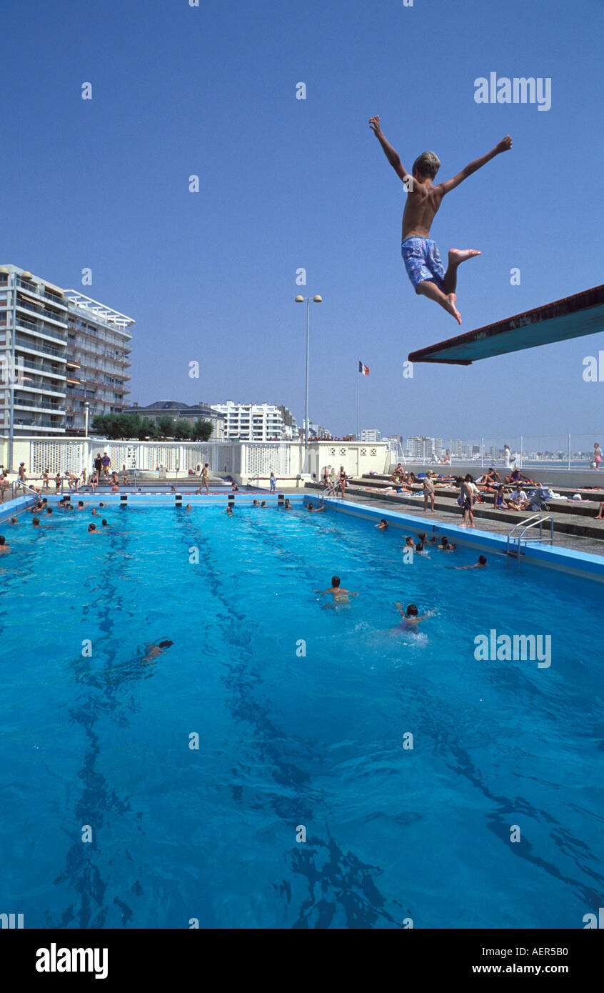 Boy 10 15 Years leaping off springboard into a hotel swimming pool at ...