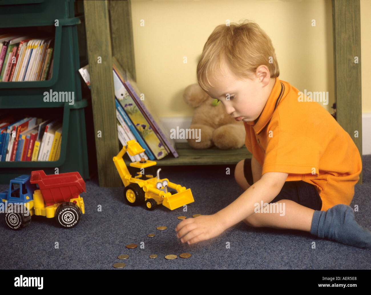 Young boy counting out coins Stock Photo - Alamy