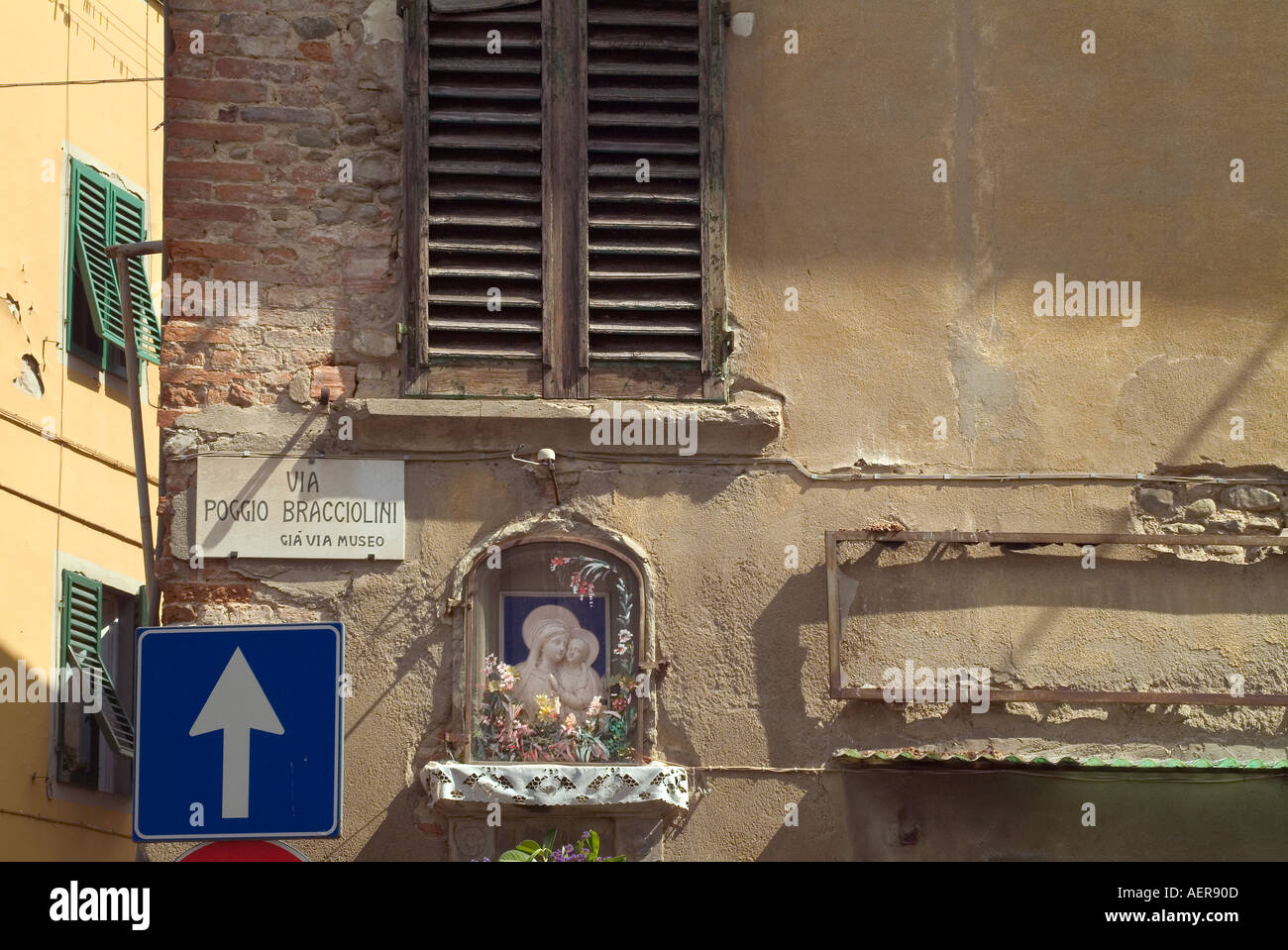 Tuscany Italy Detail of shutters and street with shrine to the Virgin ...