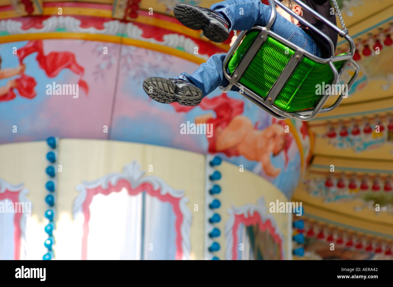 Flying by the merry go round Stock Photo - Alamy