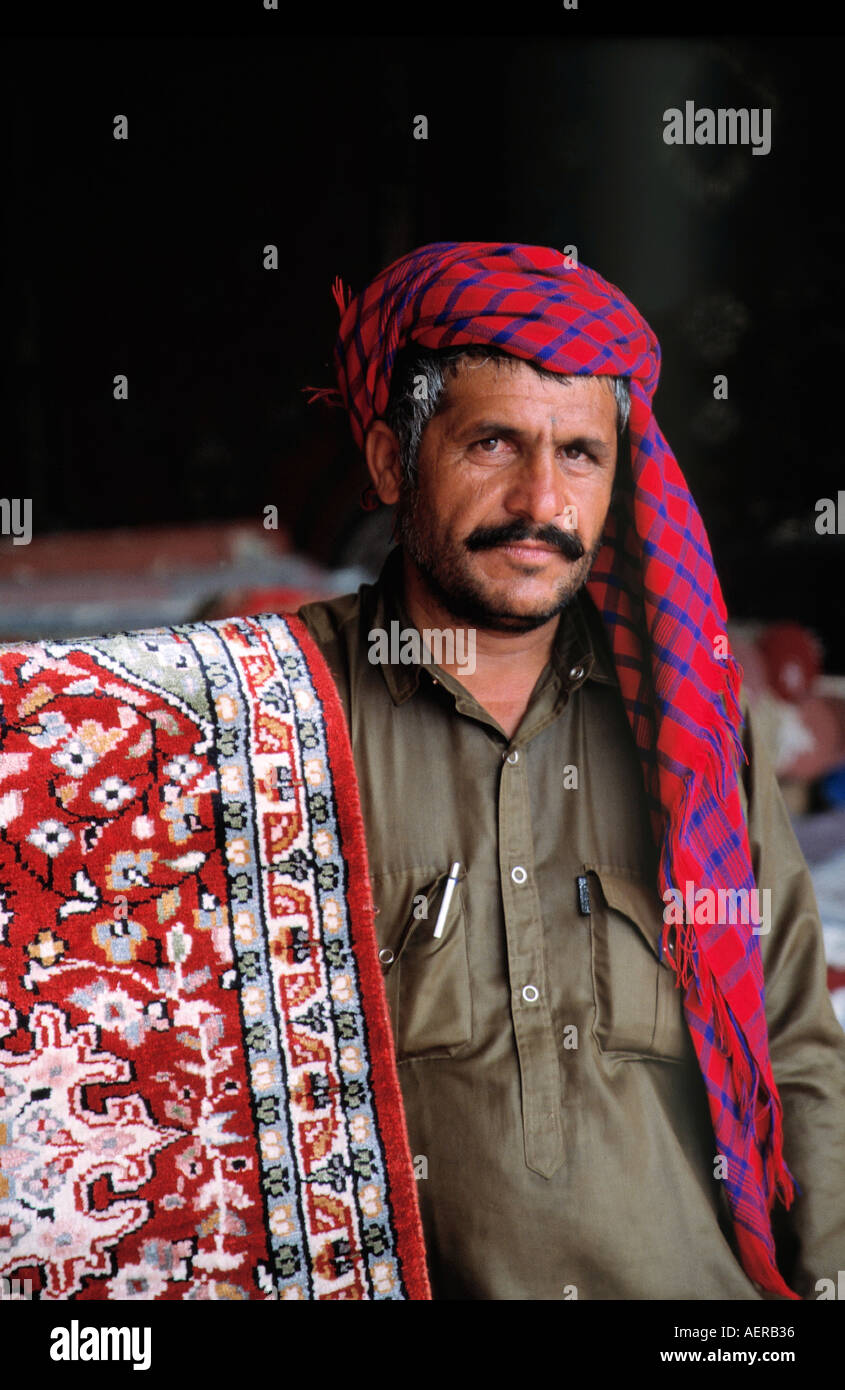 portrait of carpet seller at market emirate of fujairah united arab ...