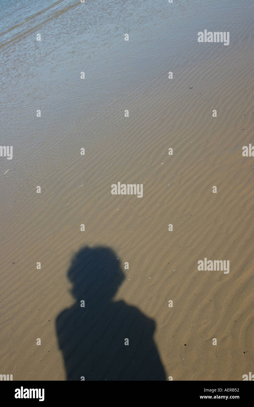 Shadow of a person on a beach Stock Photo - Alamy