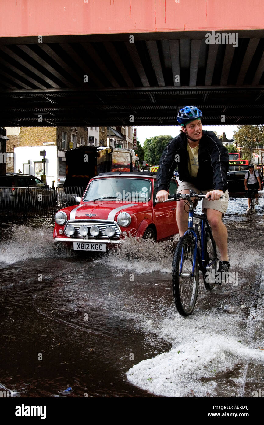 Commuters making their way through flooding after a freak hail storm in ...