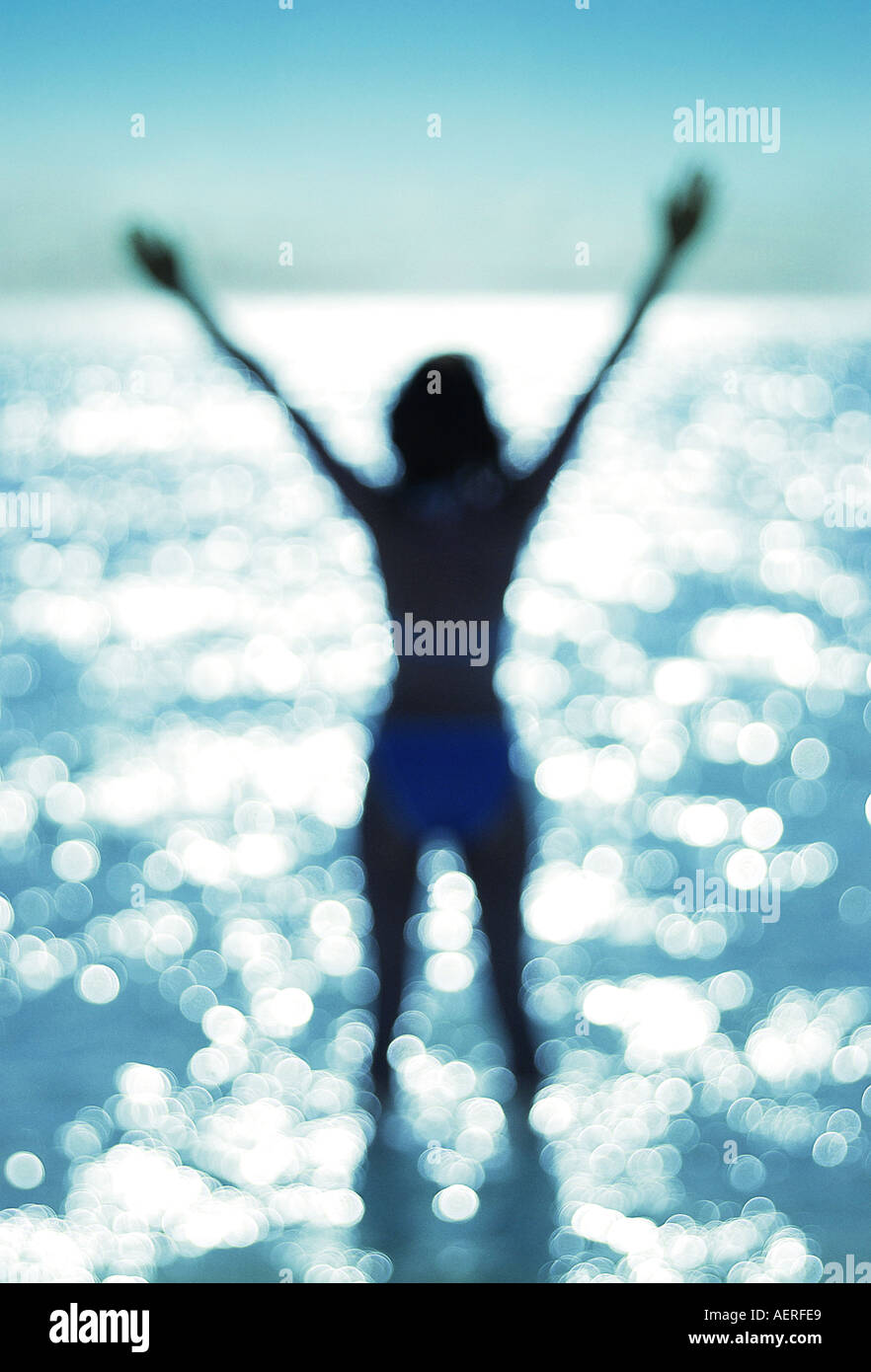 woman standing in the sun on sea shore Stock Photo - Alamy