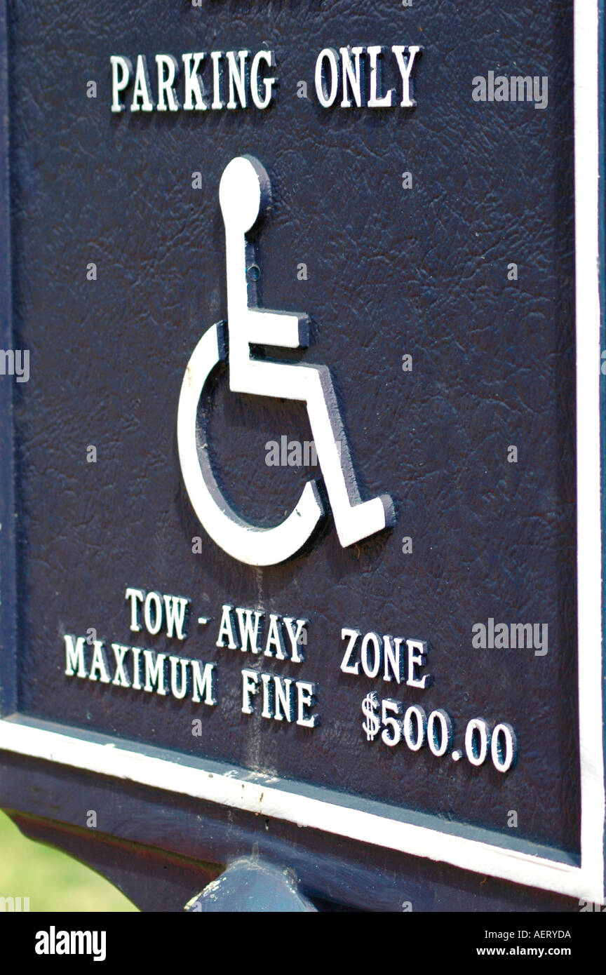 Handicapped parking sign in public park and site is a tow away site ...