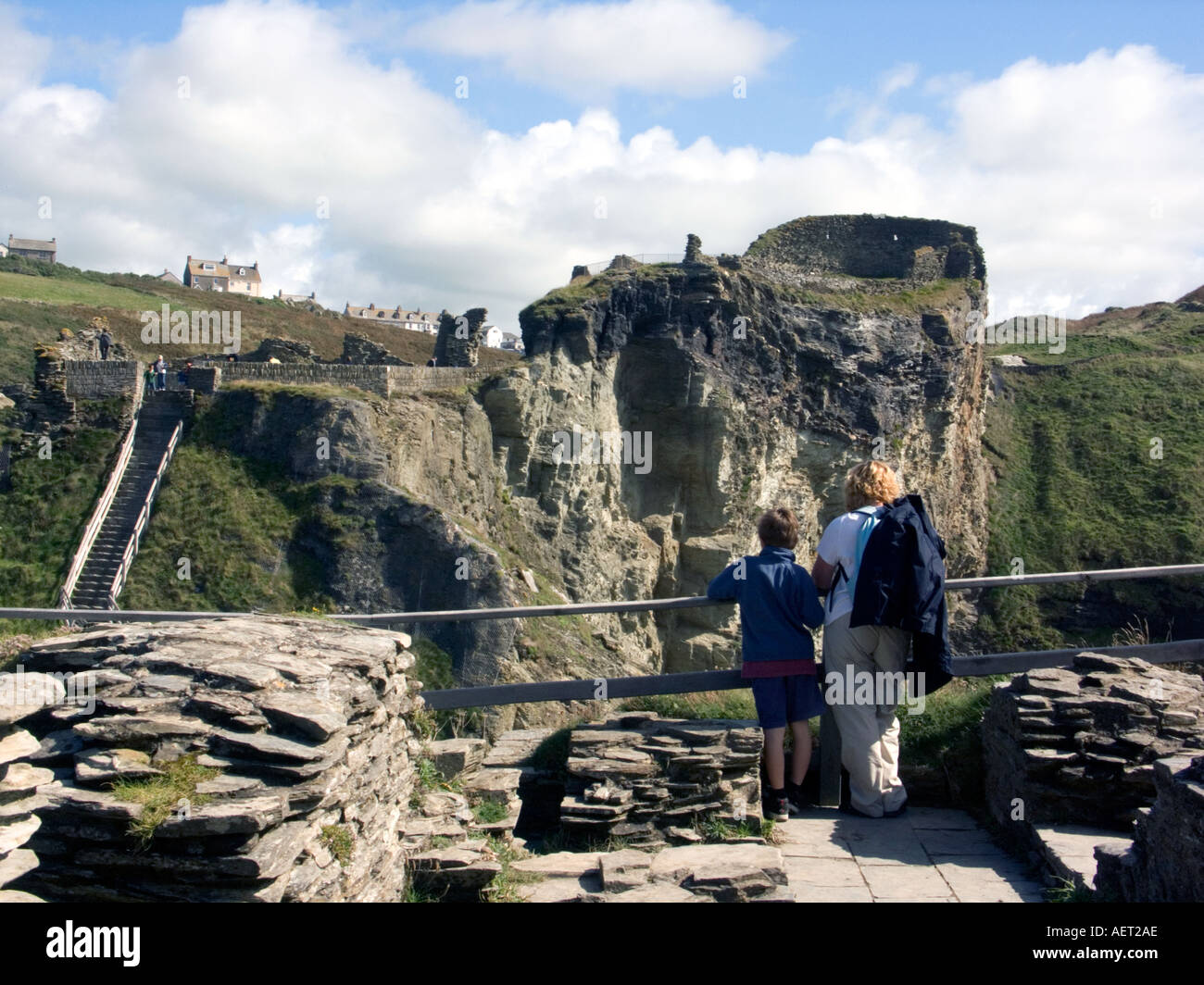 Father and Son admire the Sandstone Cliffs and Stone Walls of Tintagel ...