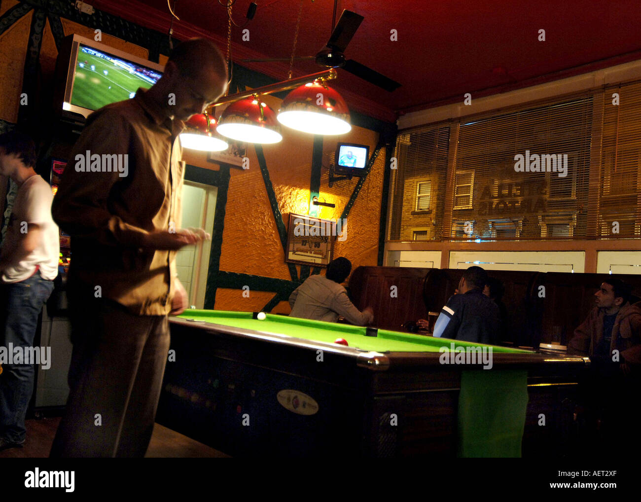 A typical London pub scene with a man playing pool Stock Photo - Alamy