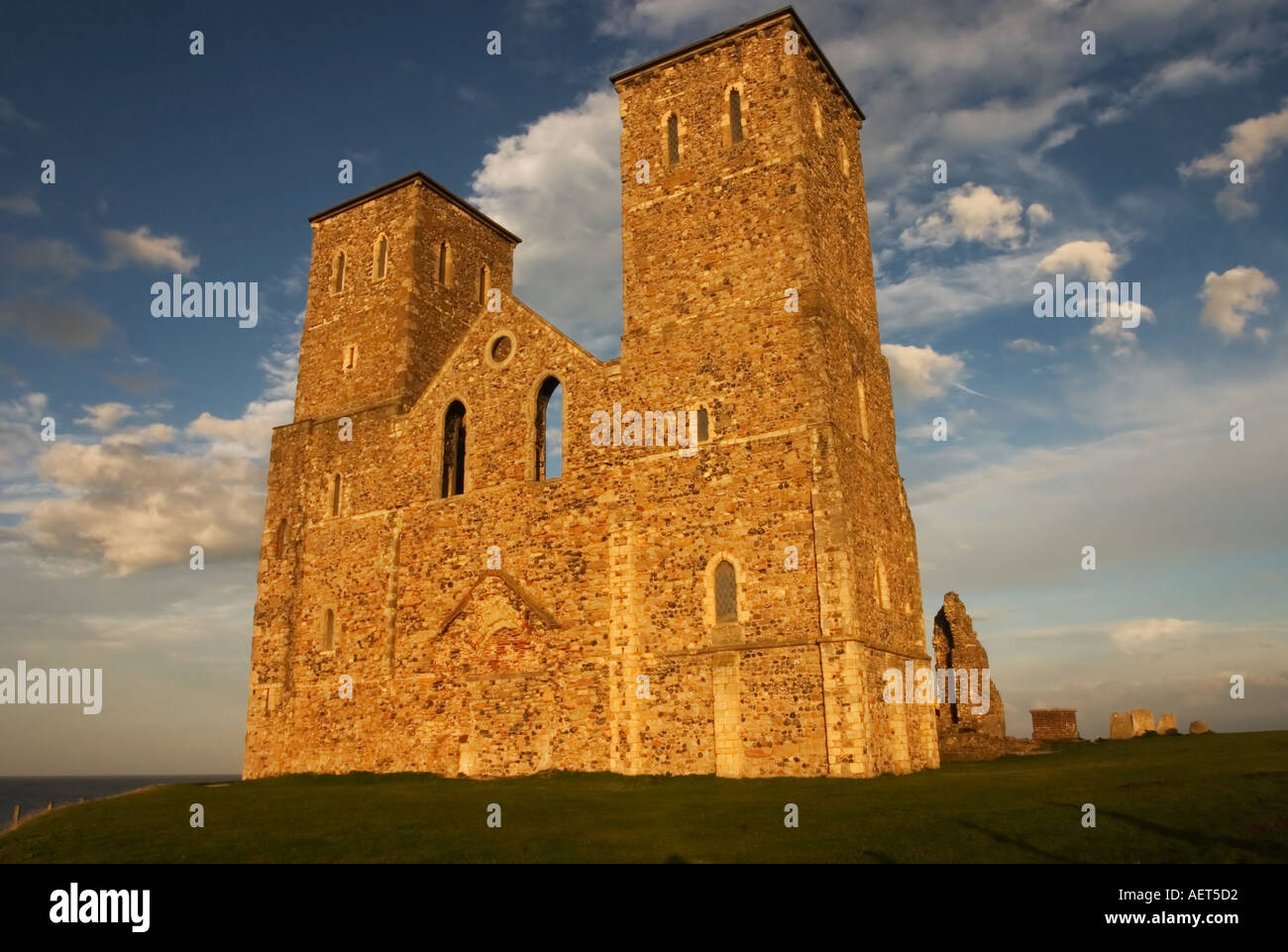 late afternoon sunlight illuminates the remains of Reculver Church on ...