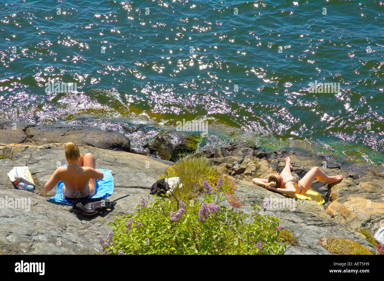 Two women sunbathing in central Stockholm Sweden EU Stock Photo - Alamy
