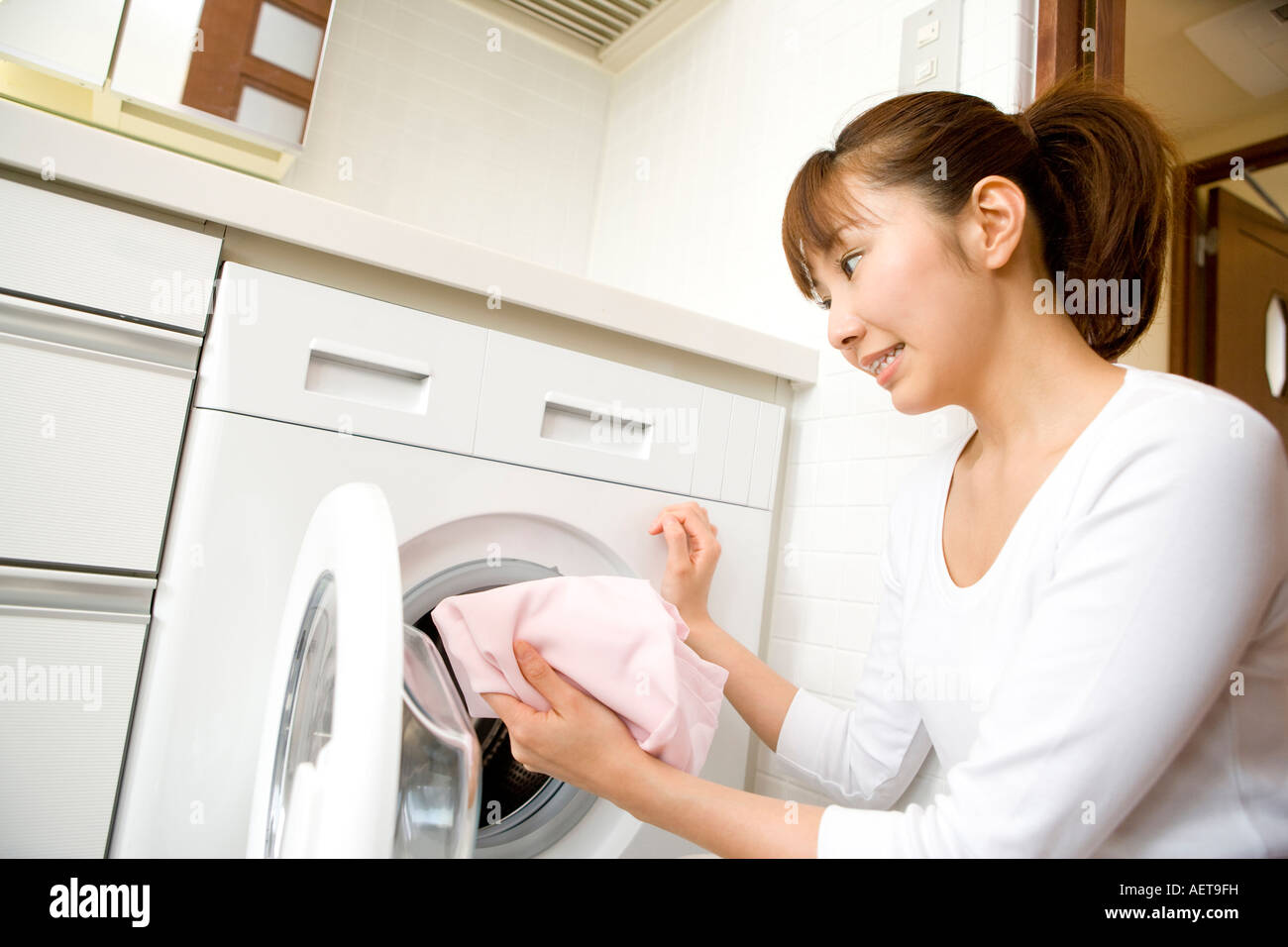 Woman washing clothes Stock Photo - Alamy