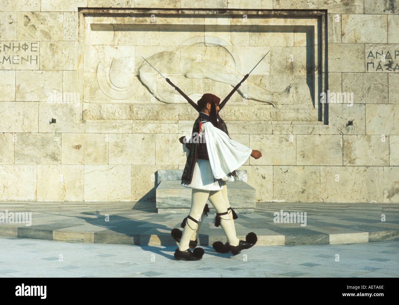 Two Greek National Guard evzones march past each other at the Tomb of ...