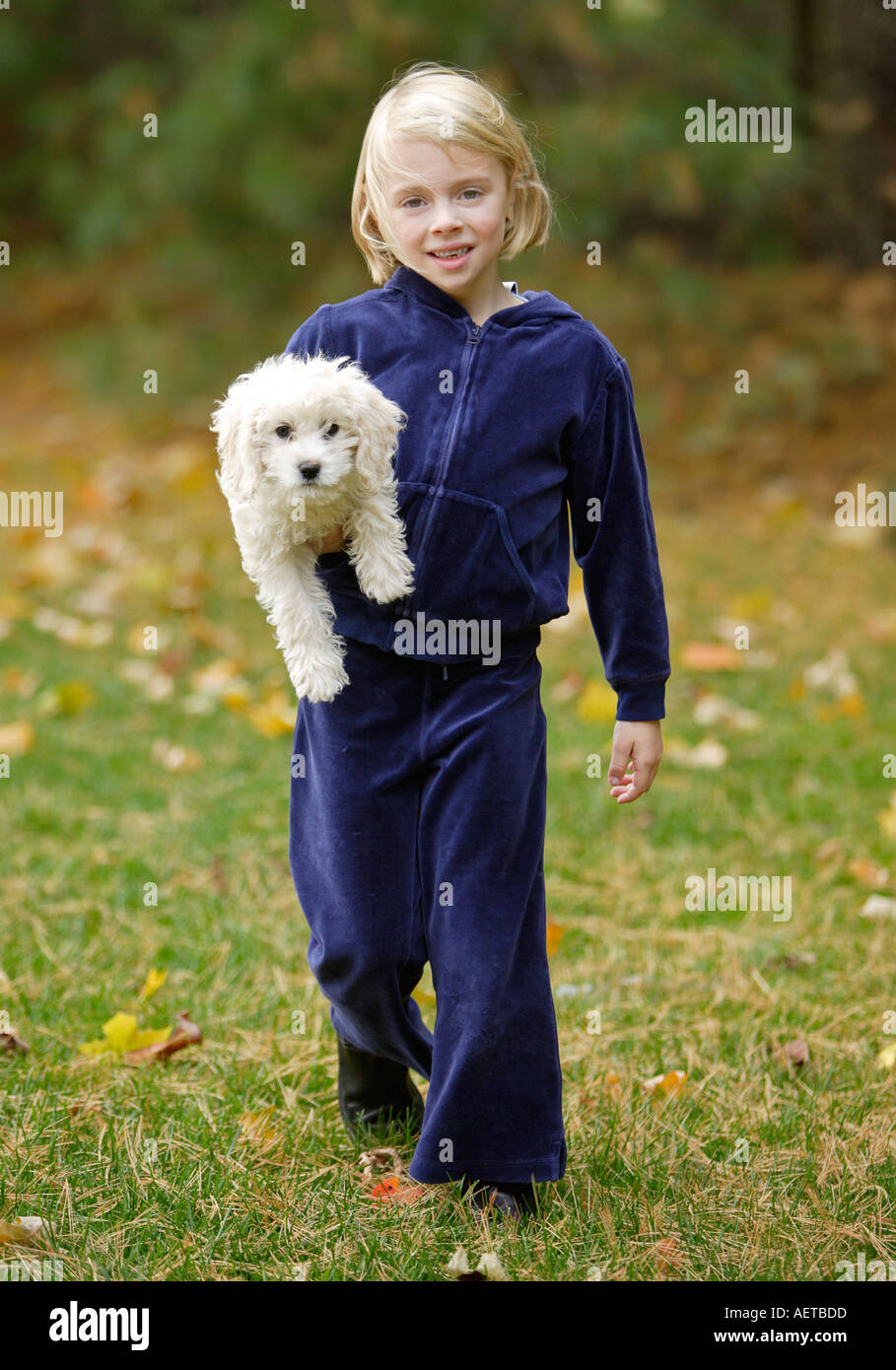 Child carrying her pet dog Stock Photo - Alamy